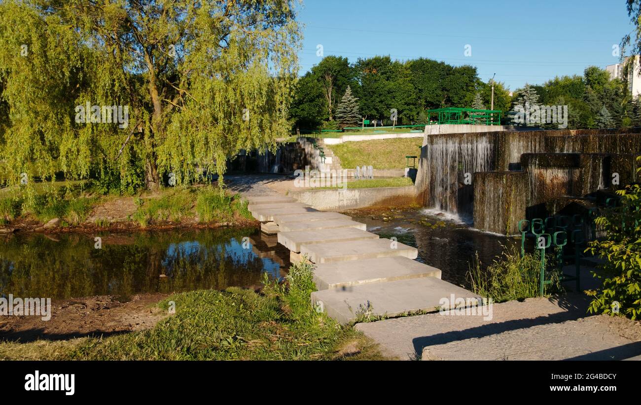 Urban water system. The river flowing in the city. With fountains and ...