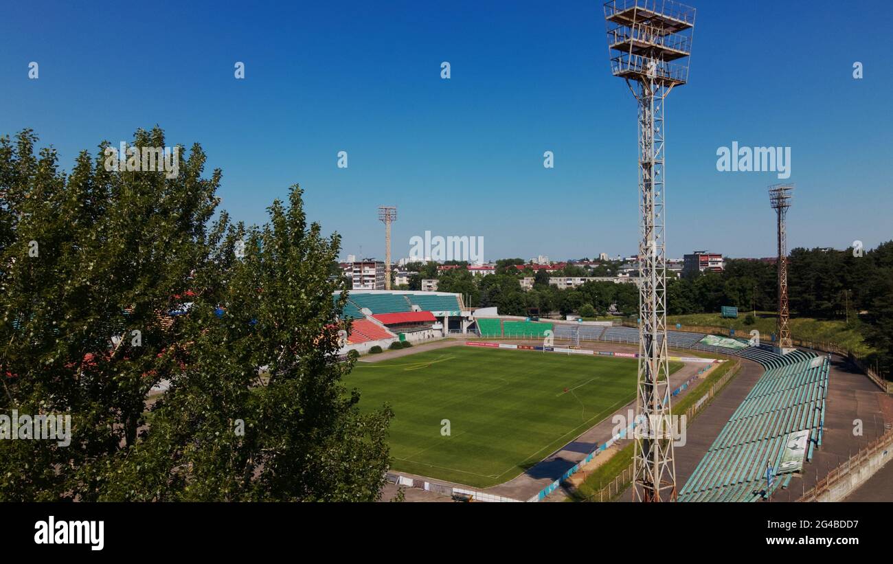 Football stadium in the city park. A green field and stands are visible ...