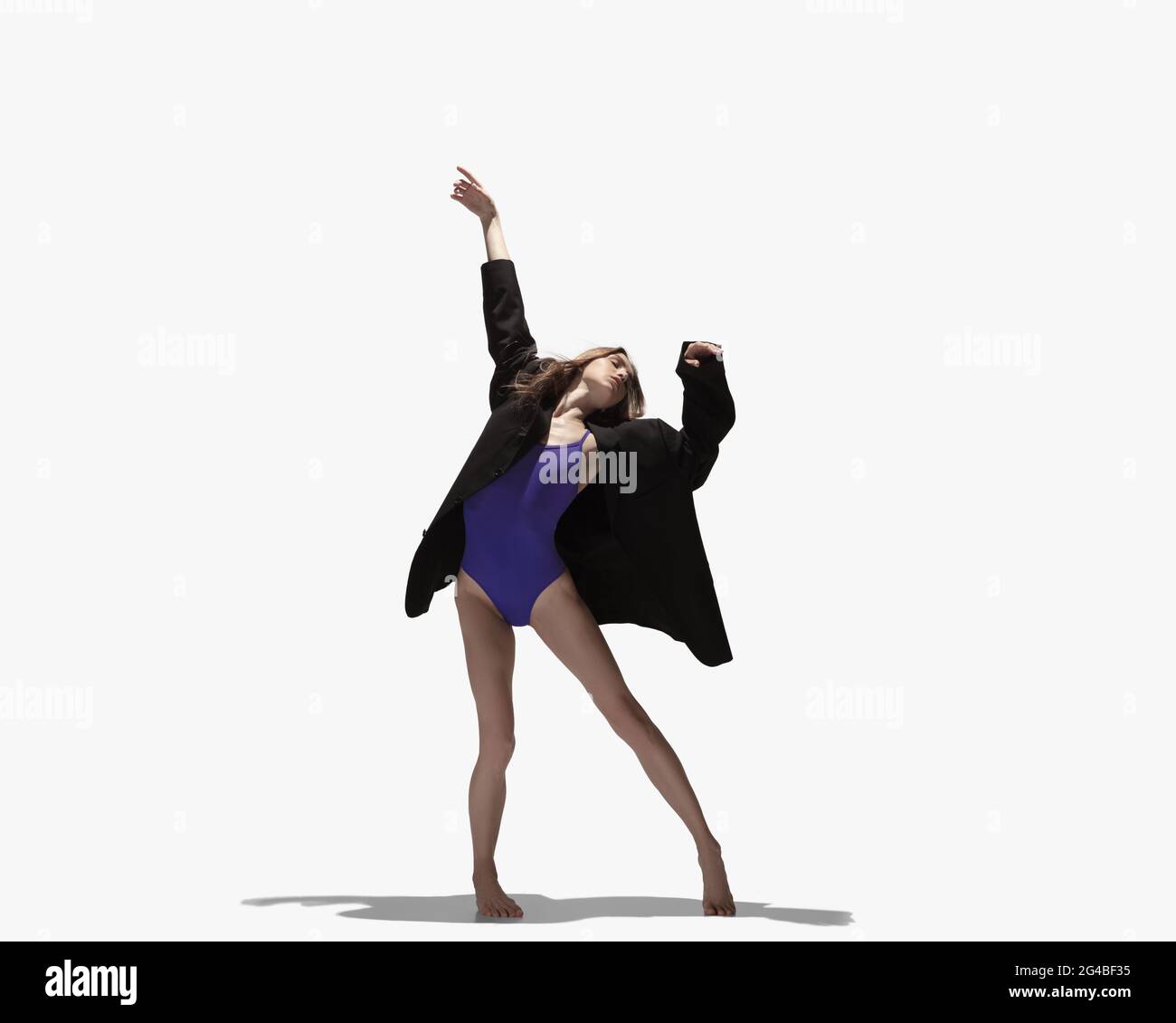 Solo. Young beautiful girl, female ballet dancer dancing isolated over ...