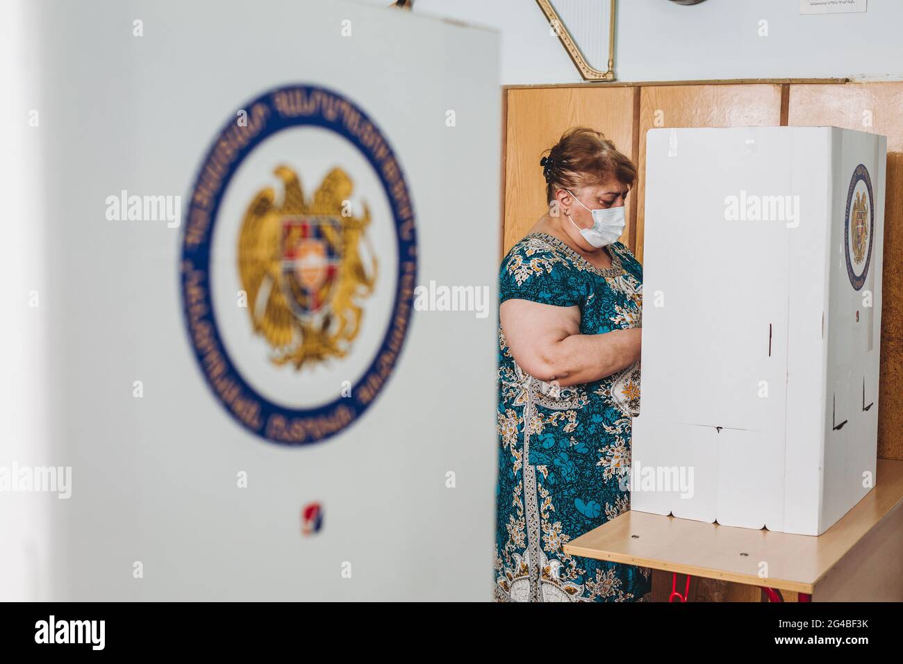 Yerevan, Armenia. 20th June, 2021. A voter casts her vote at a polling ...