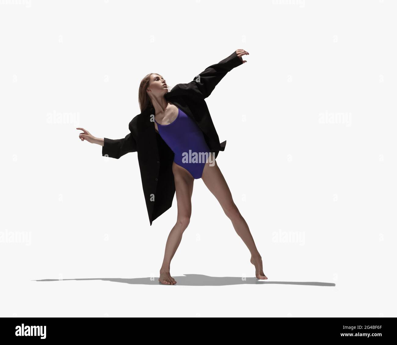 Solo. Young beautiful girl, female ballet dancer dancing isolated over ...