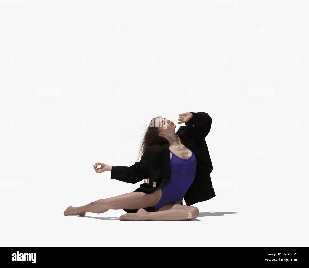 Solo. Young beautiful girl, female ballet dancer dancing isolated over ...