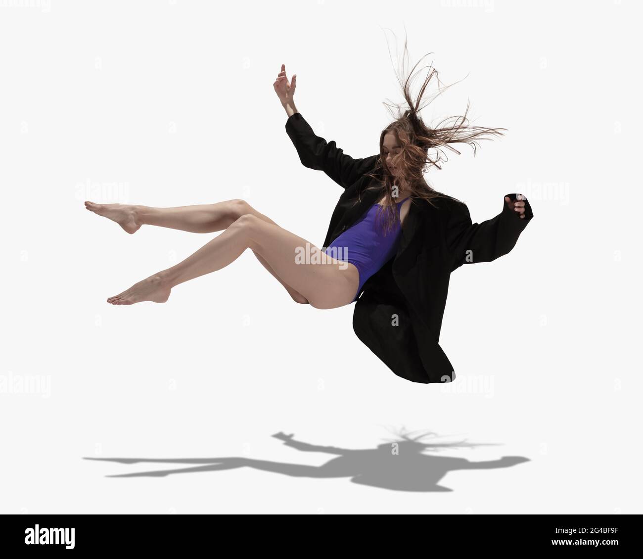 Levitation. Young beautiful girl, female ballet dancer dancing isolated ...