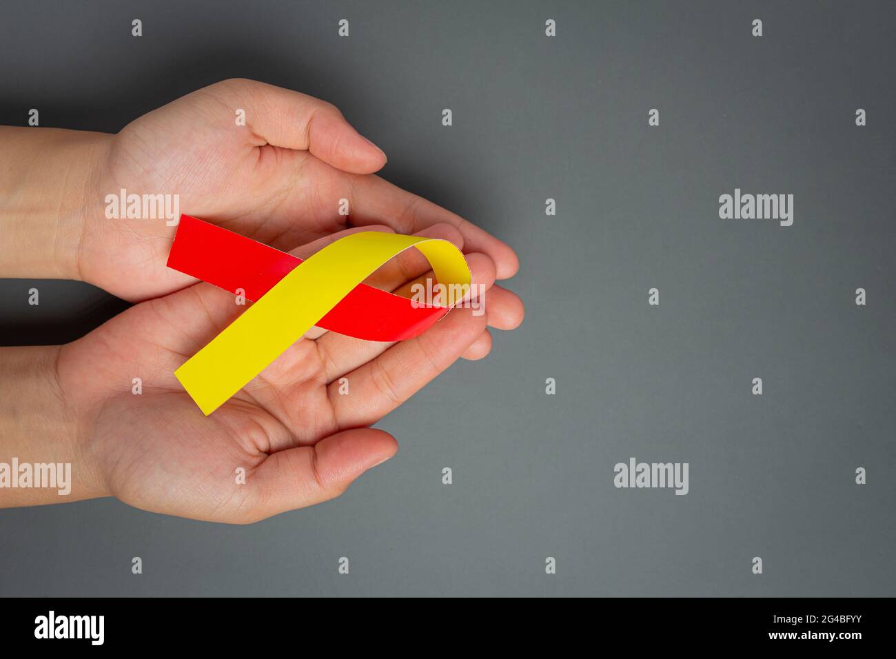 World hepatitis day awareness with red yellow ribbon Stock Photo - Alamy