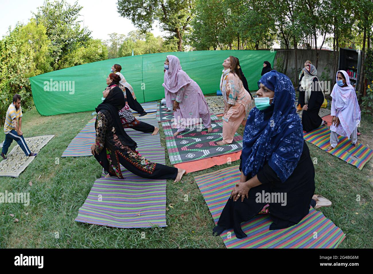 Pakistani people performing yoga session at the historical Shalimar ...