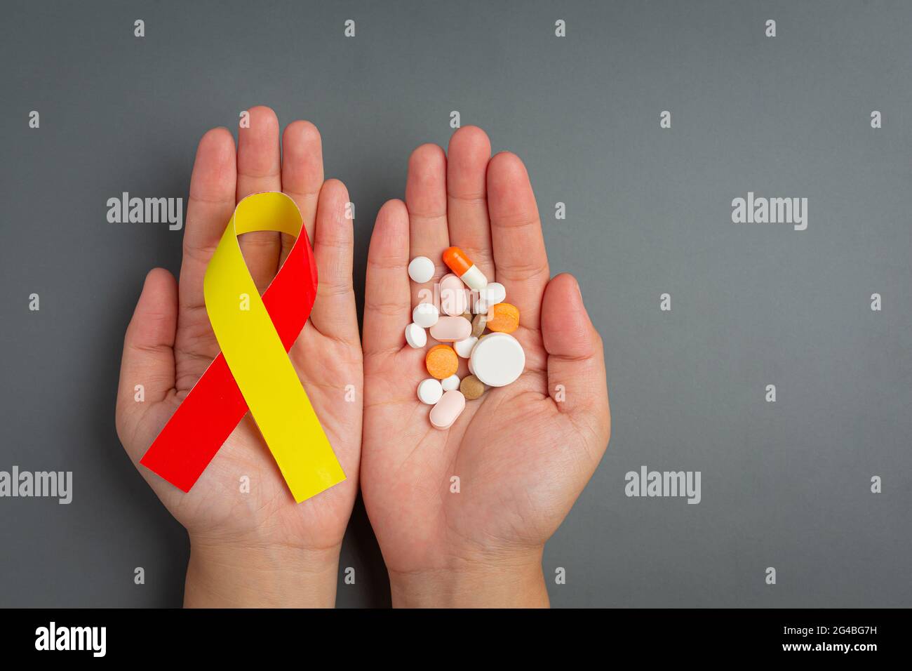 World hepatitis day awareness with red yellow ribbon Stock Photo - Alamy