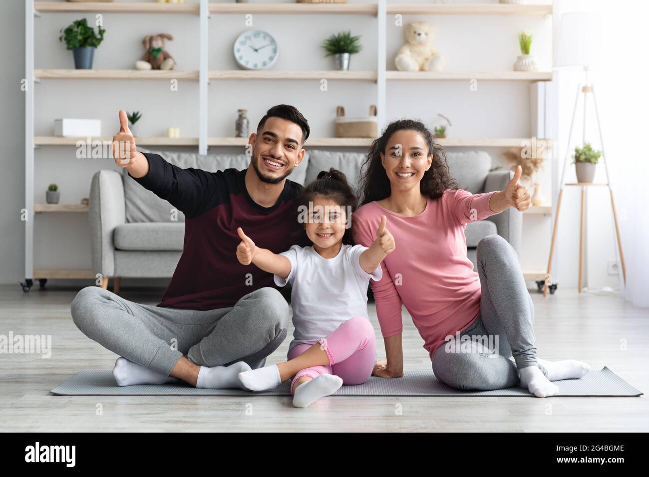 Sporty cute family exercising all together at home Stock Photo - Alamy