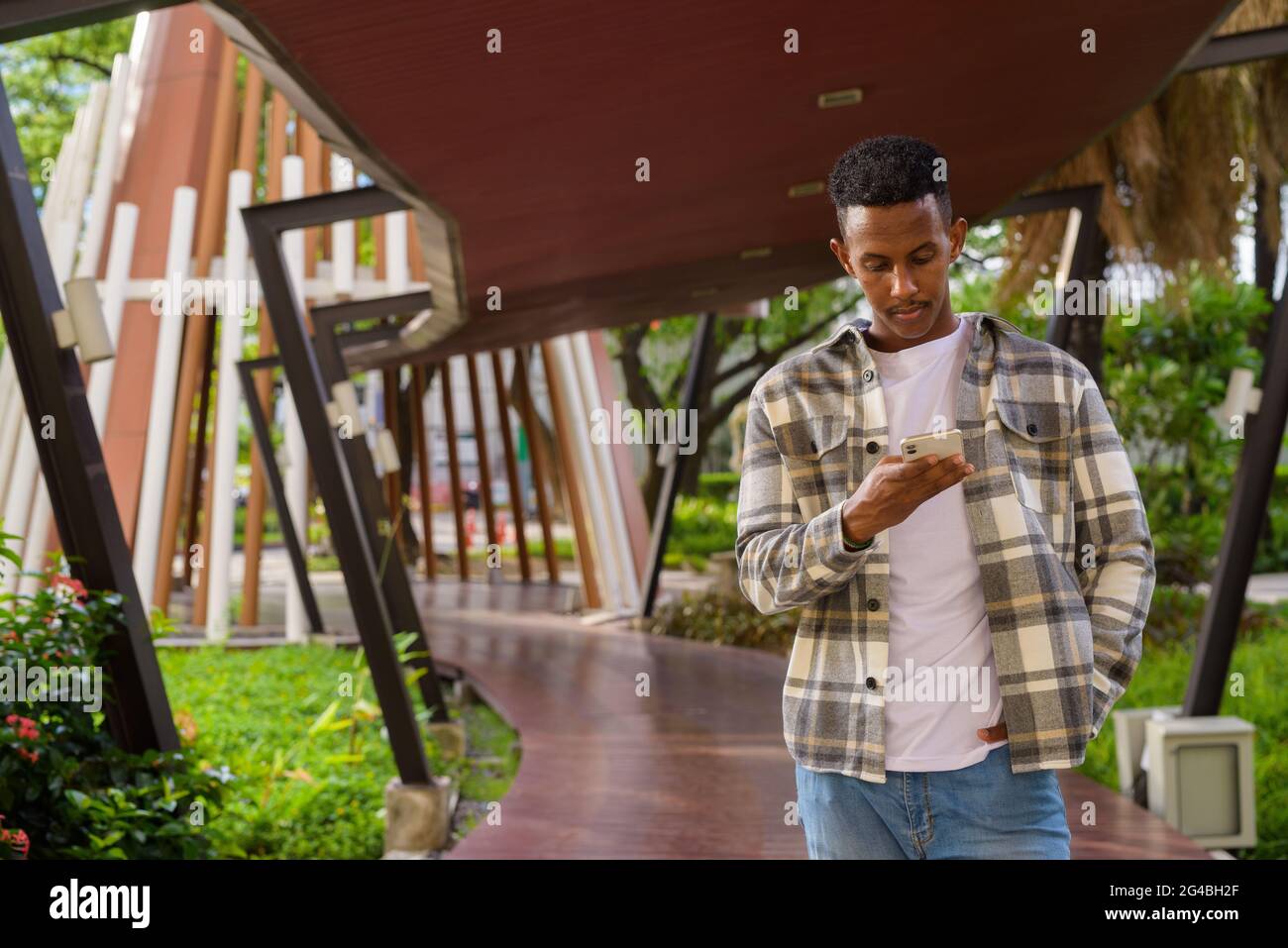 Portrait of African black man outdoors in city during summer horizontal ...