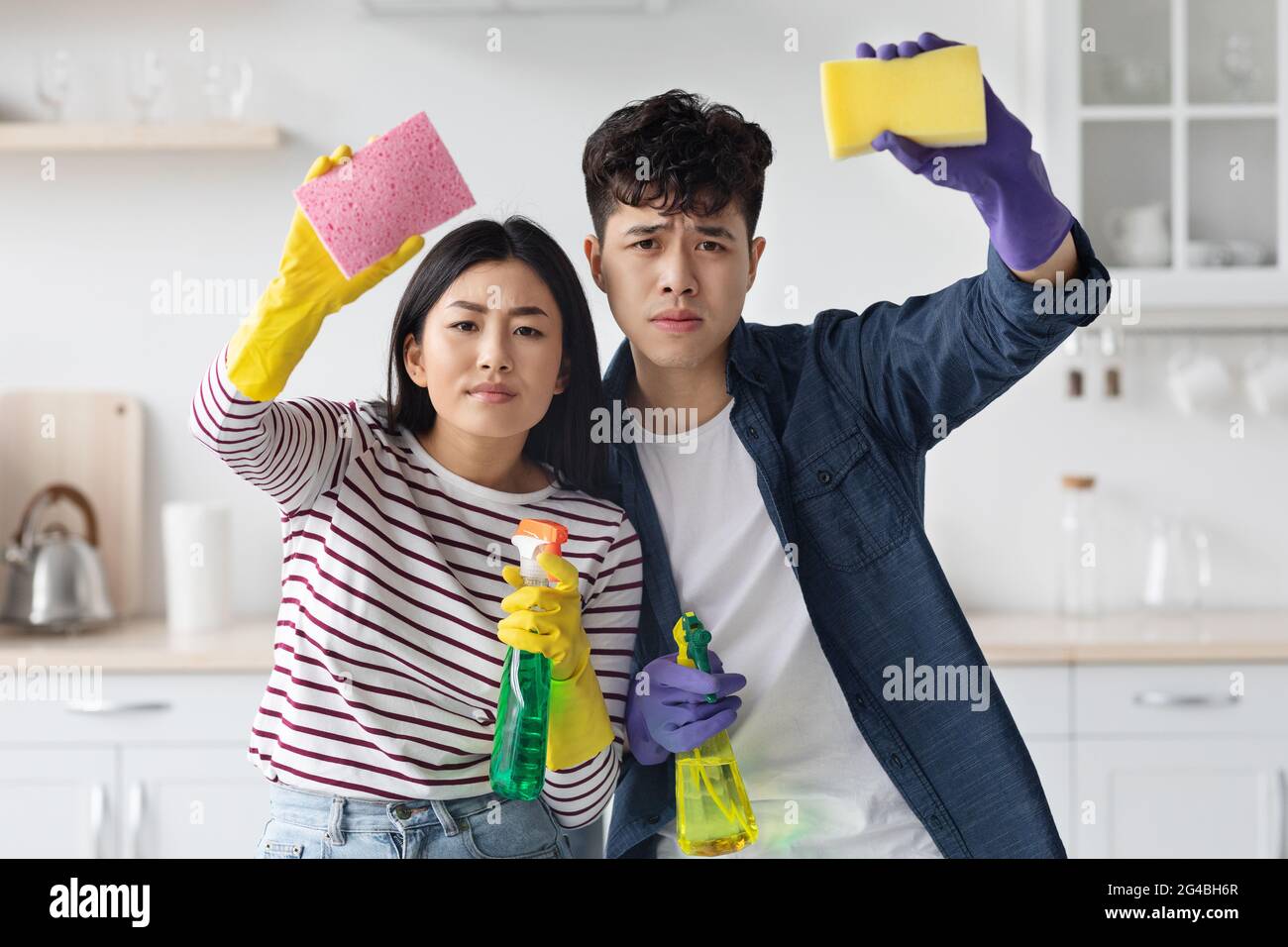 Hard-working asian man and woman house-keeping at kitchen Stock Photo ...