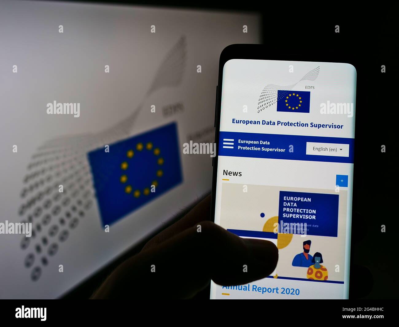 Person holding smartphone with webpage of authority European Data ...