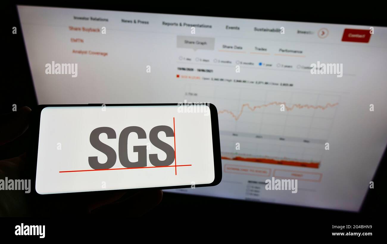 Person holding mobile phone with logo of Swiss certification company ...