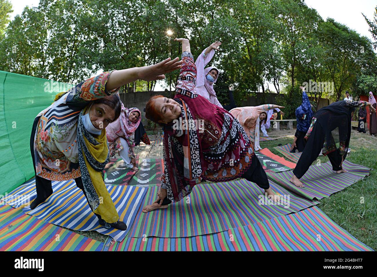 Lahore, Pakistan. 20th June, 2021. Pakistani people performing yoga ...