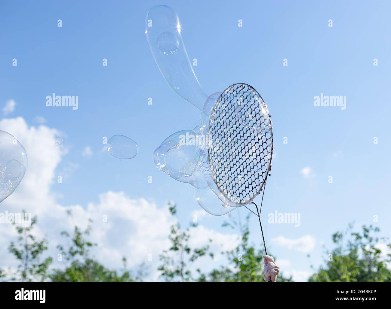 Blowing bubbles blue sky hi-res stock photography and images - Alamy