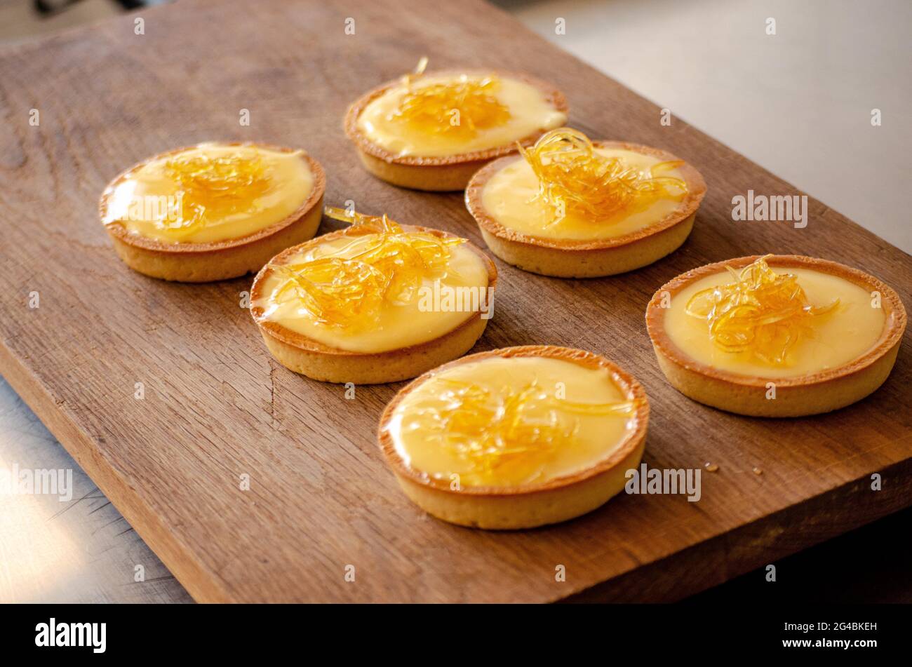 A closeup shot of sweet lemon tarts on a wooden cutting board Stock ...