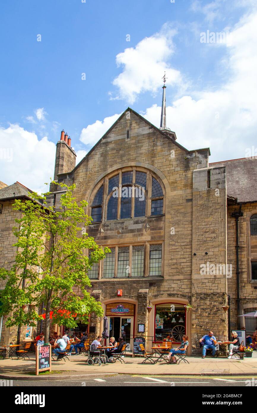 People sitting outside enjoying the sunshine eating and drinking at a ...