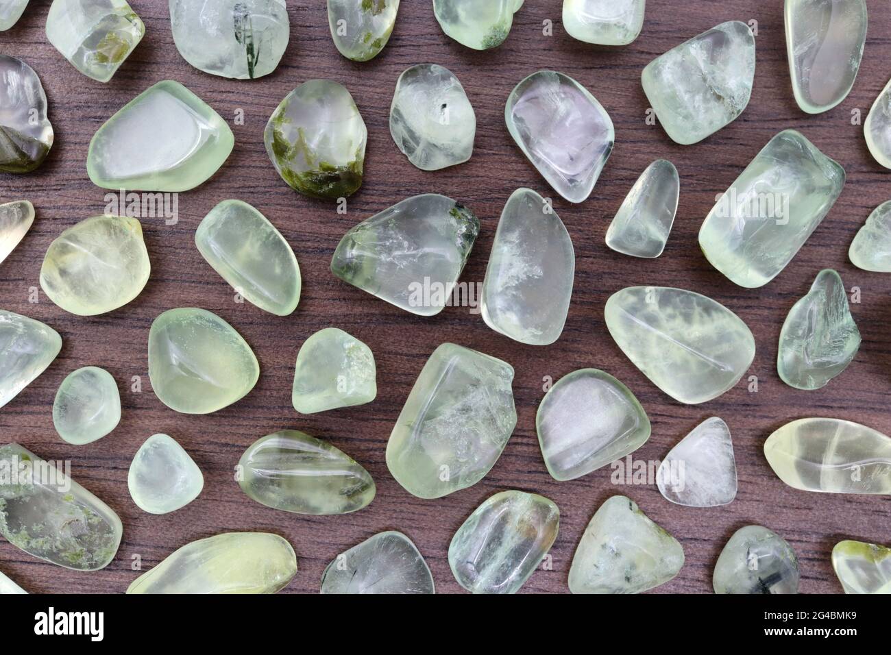 Prehnite rare jewel on half brown varnished wood texture. Sparse ...