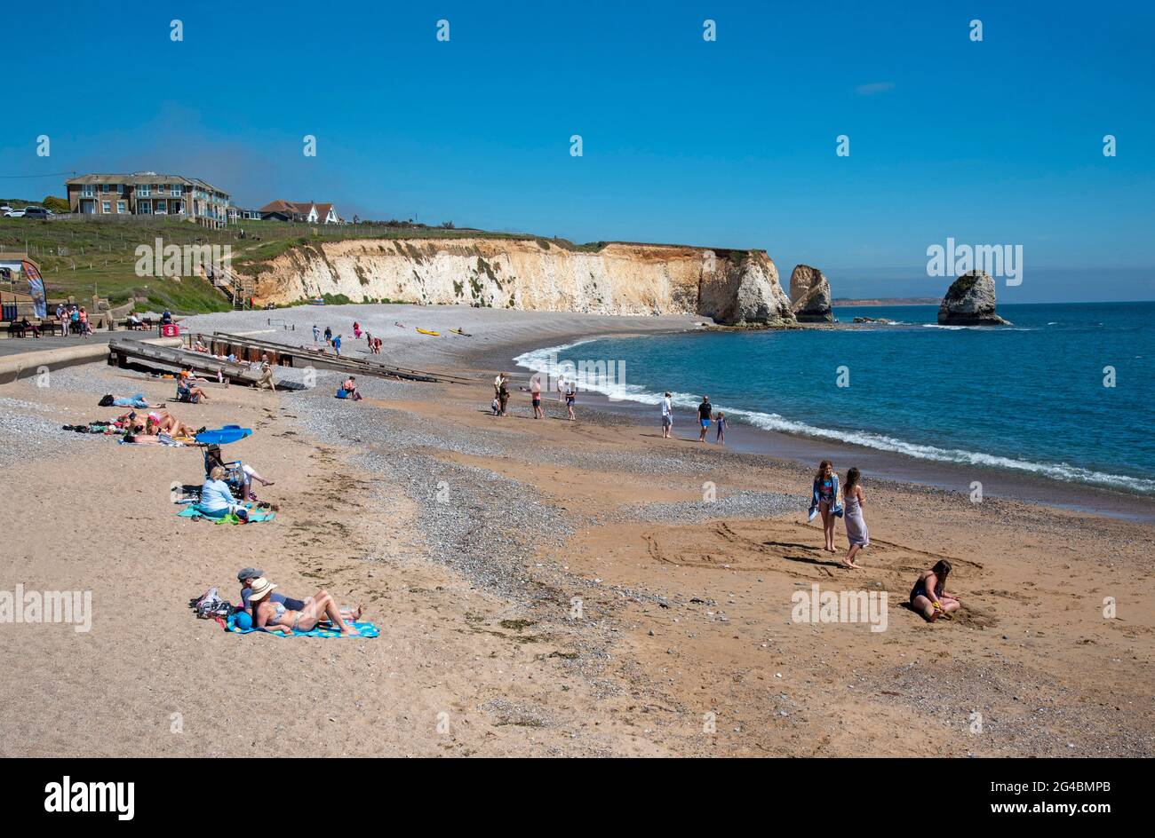 Freshwater Bay, Isle of Wight, UK.2021. Holidaymakers on the beach at ...