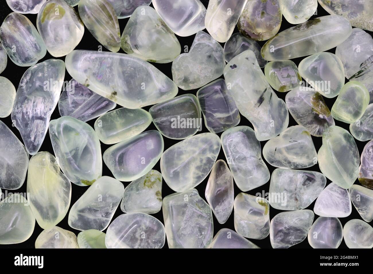 Prehnite heap up jewel stones texture on black background. Pile mineral ...