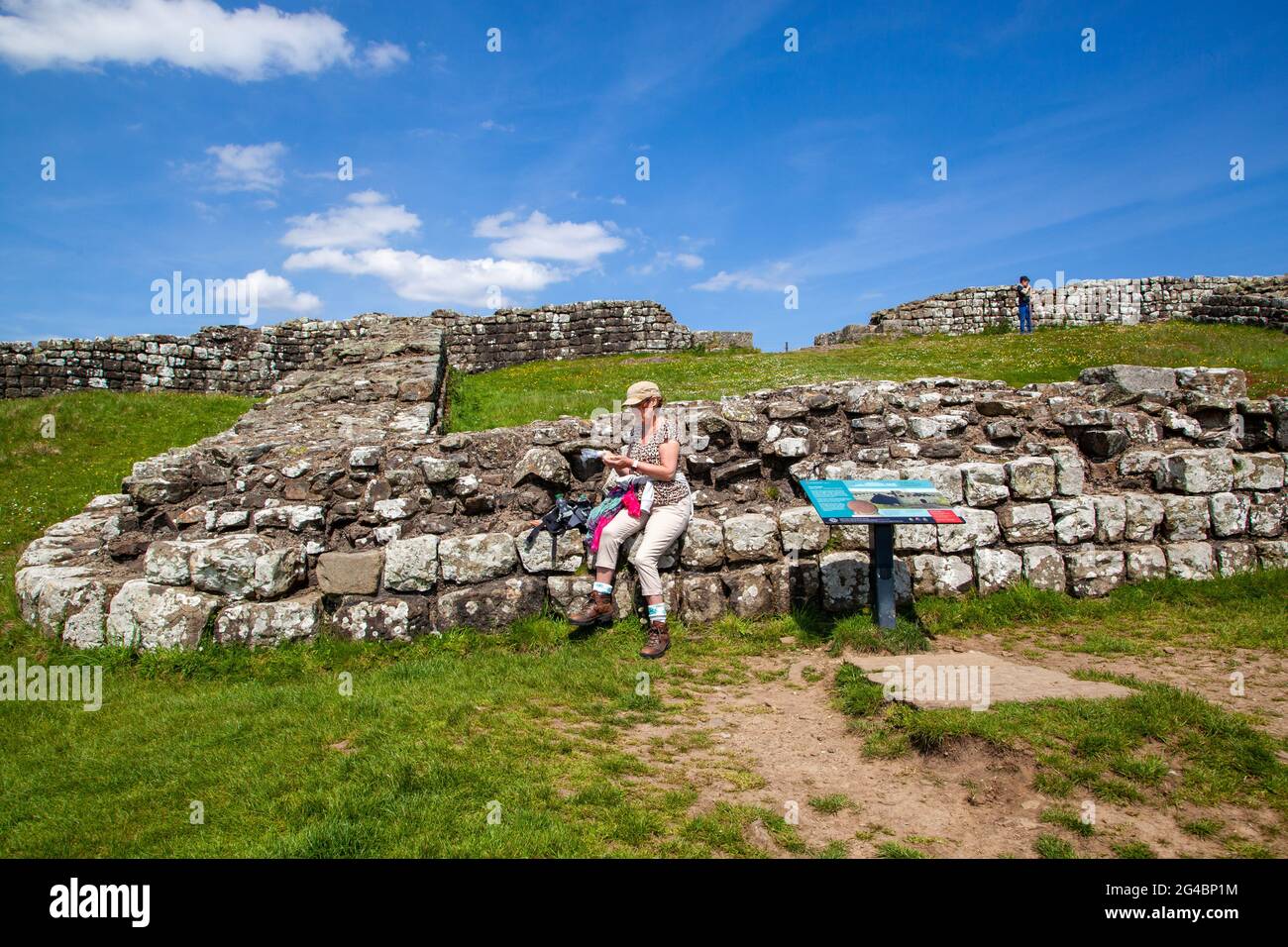 Woman stopped to rest at milecastle 42 Cawfields while walking along ...
