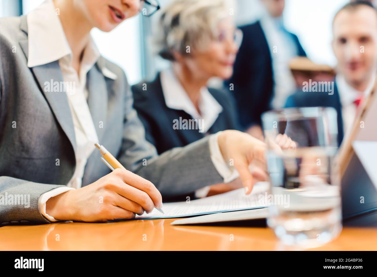 Close-up on woman taking notes during business meeting Stock Photo - Alamy