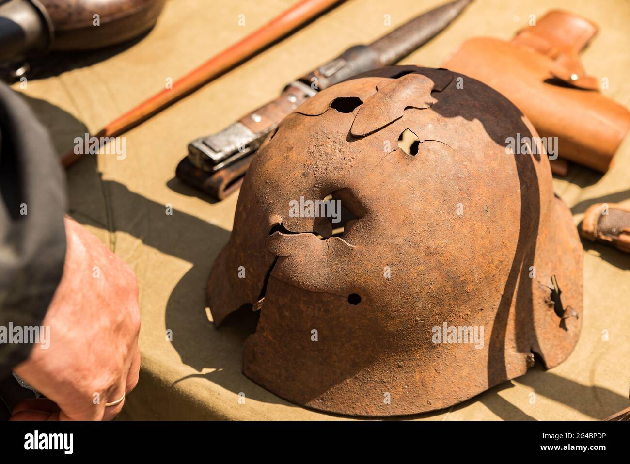An old rusty WWII army helmet lies on a display table close up Stock ...