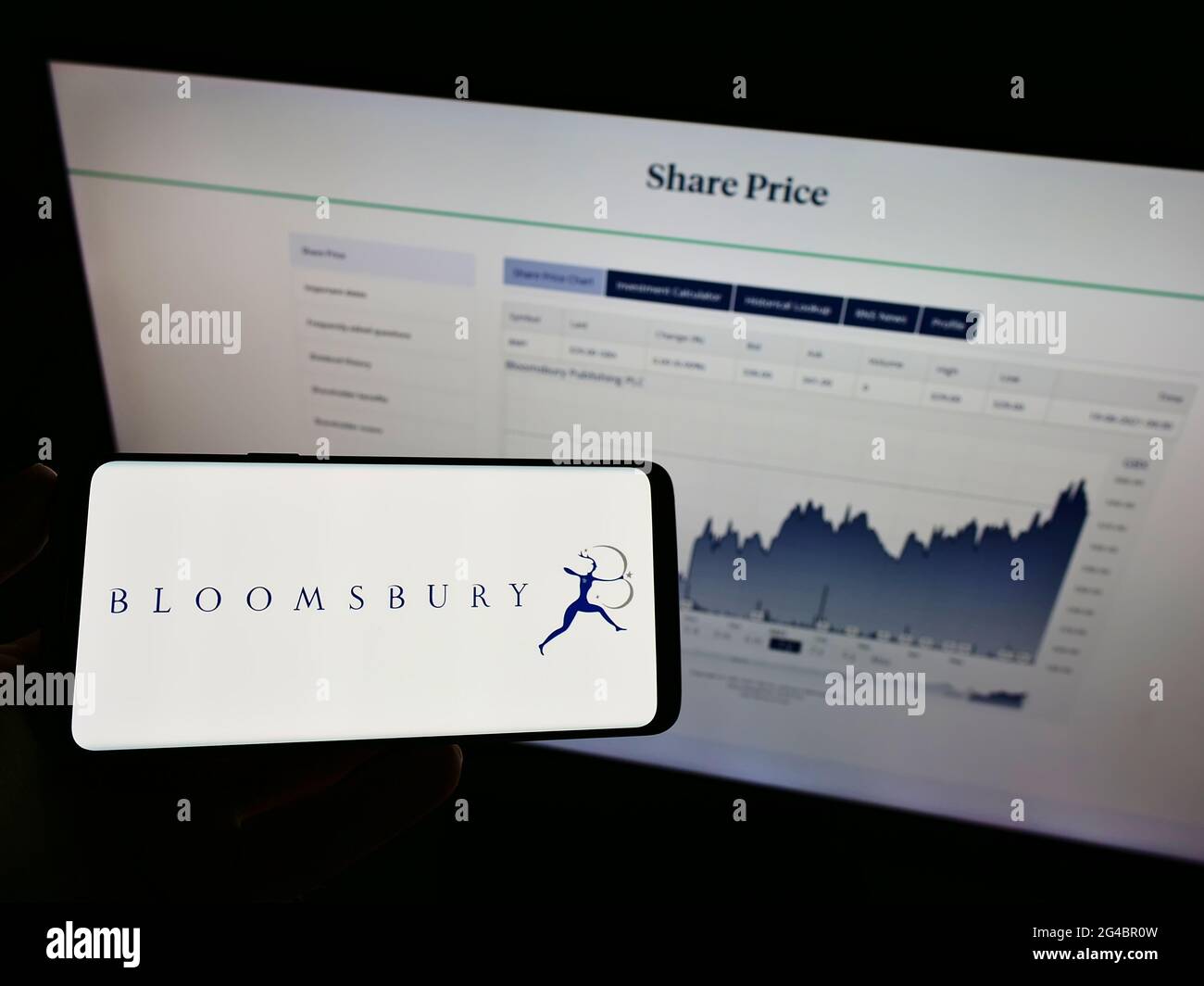 Person holding smartphone with logo of British publisher Bloomsbury ...
