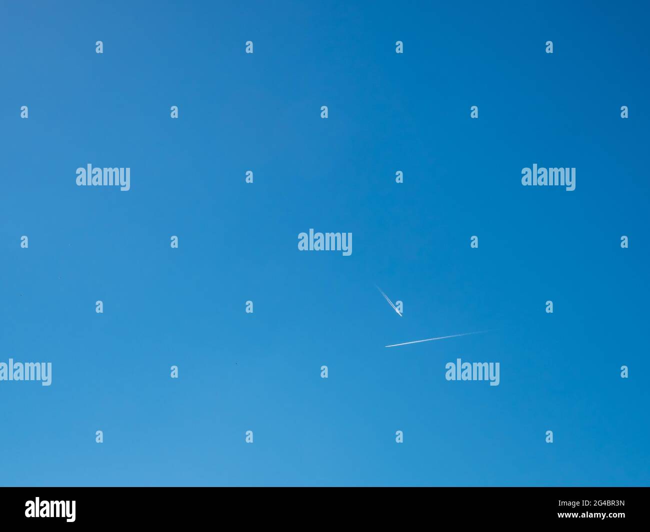 Cloud and jet contrail with blue sky background Stock Photo - Alamy
