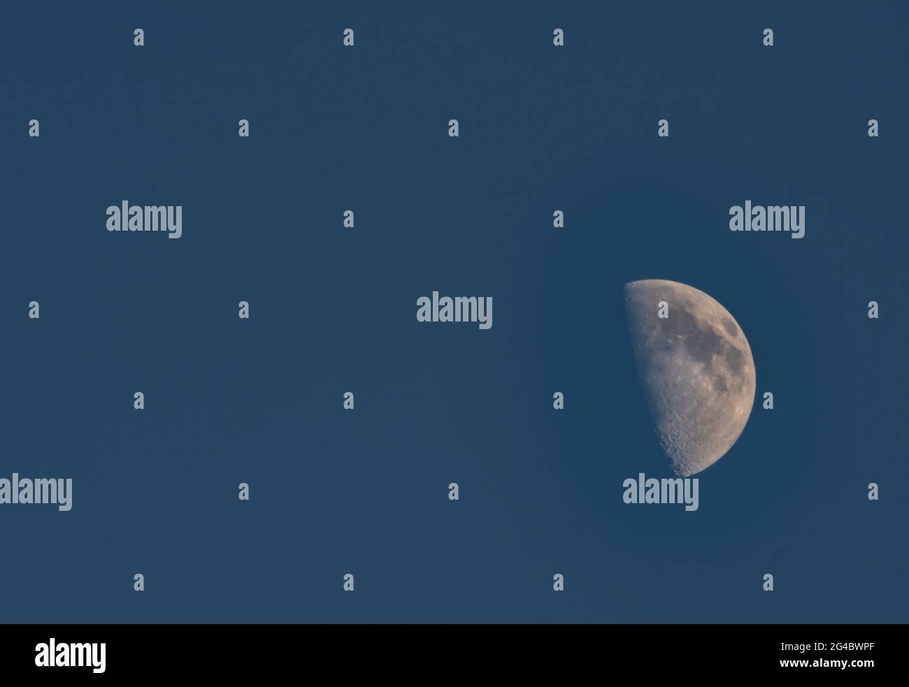 Half moon on dark blue color sky and orange light Stock Photo - Alamy