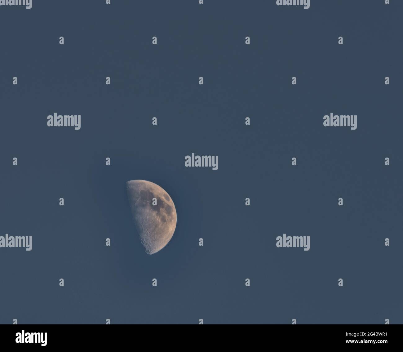 Half moon on dark blue color sky and orange light Stock Photo - Alamy