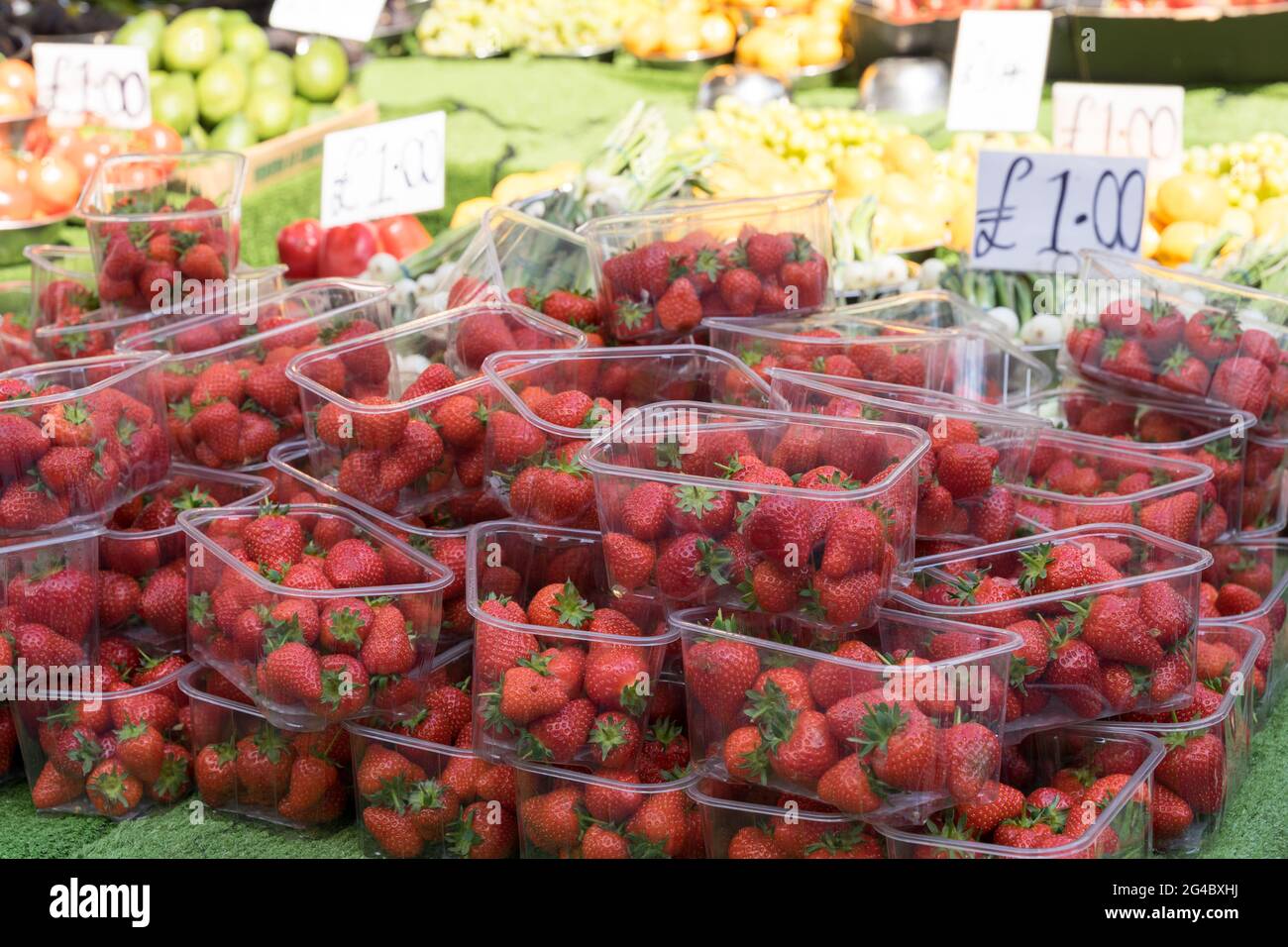 Boxes of fresh strawberries for sale at flee market stall, sunny summer ...