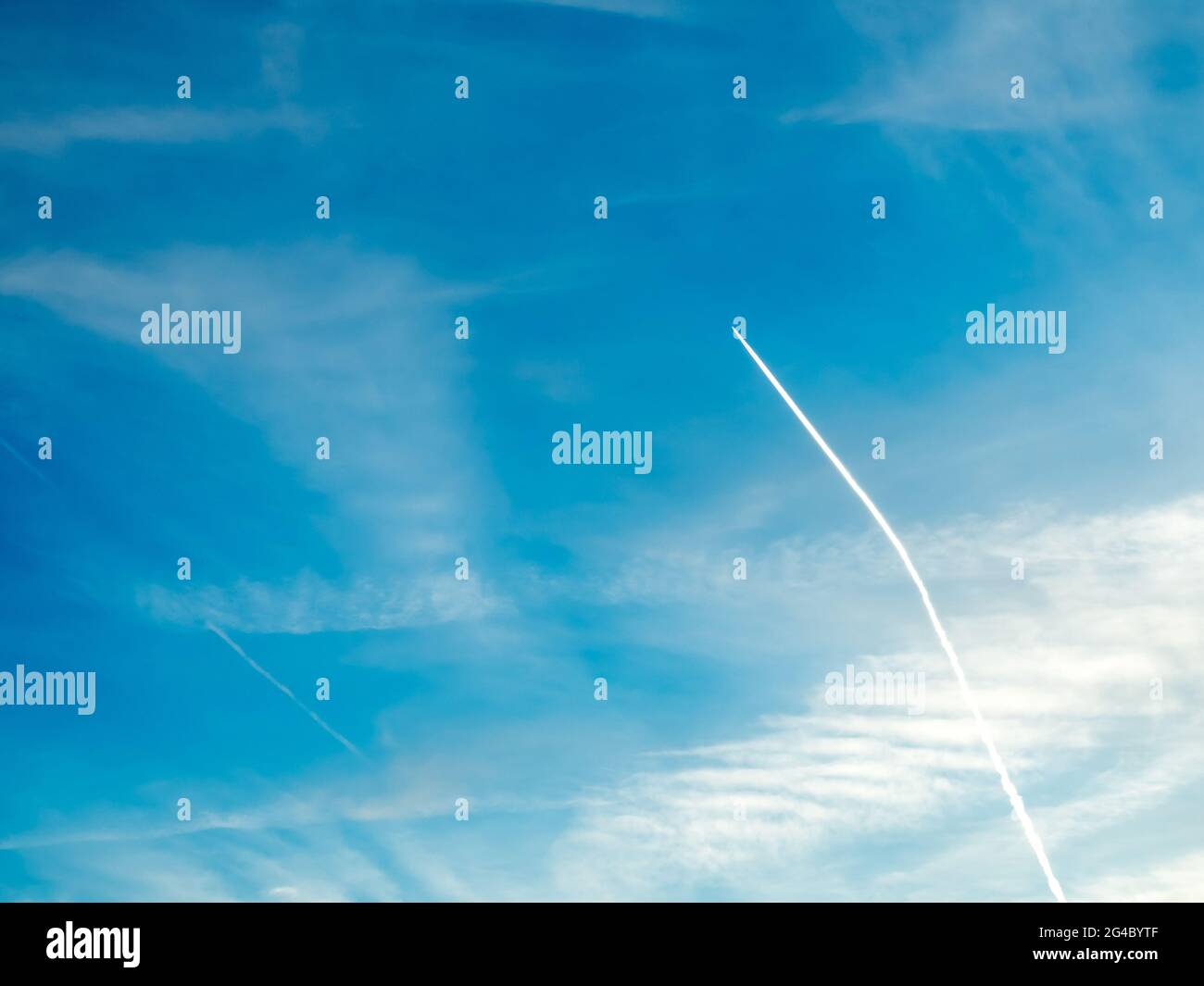 Cloud and jet contrail with blue sky background Stock Photo - Alamy