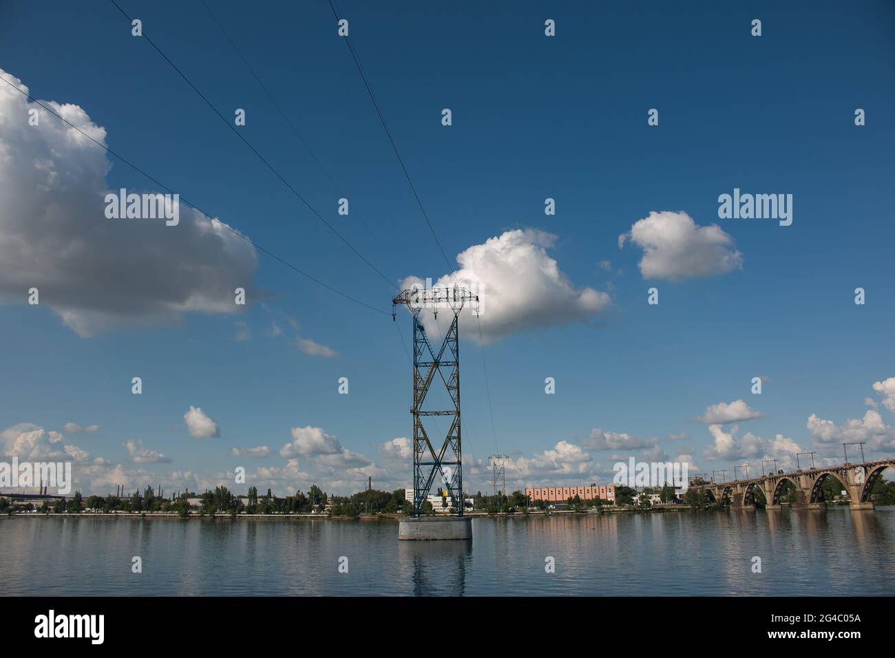 High-voltage pylons of power lines on the river. Metal pylons of high ...