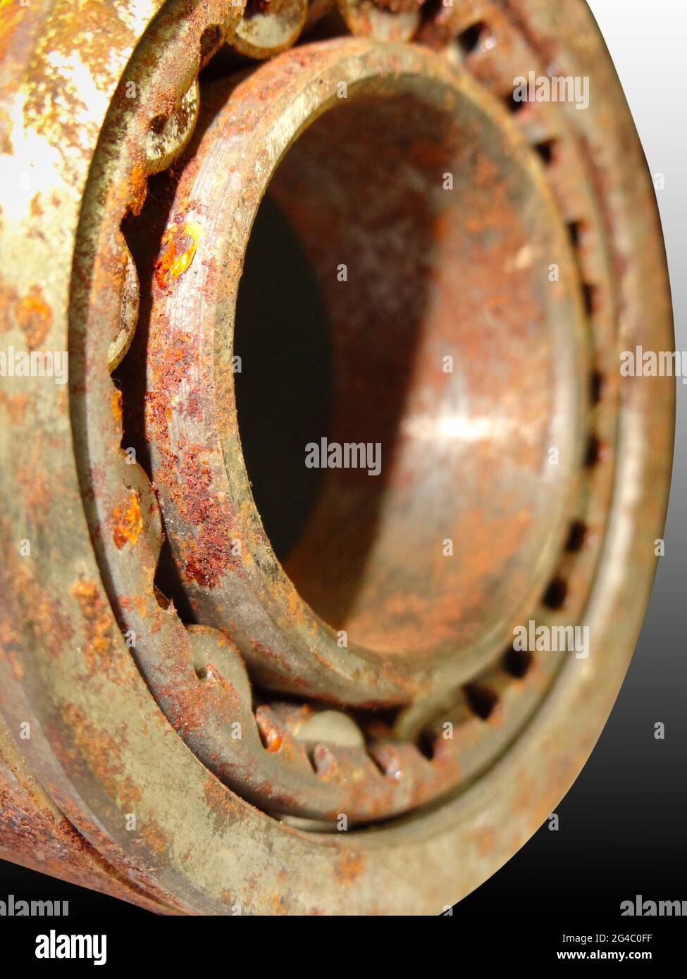 A vertical shot of an old rusty ball bearing isolated on white ...