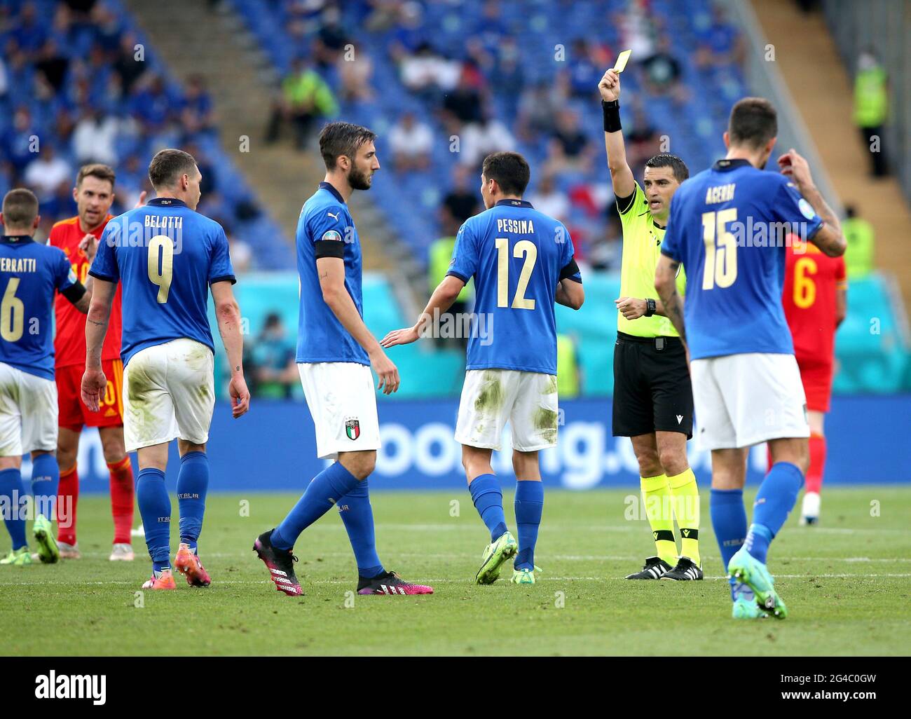 Referee Ovidiu Alin Hategan shows a yellow card to Italy's Matteo ...