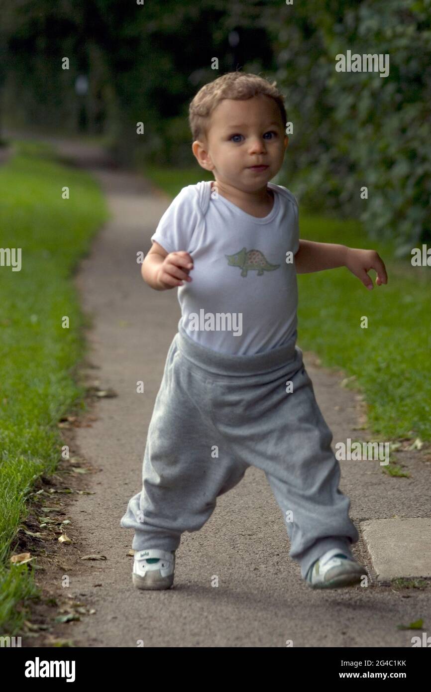 happy little toddler boy taking his first steps outdoors Stock Photo ...
