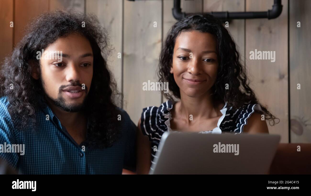 Happy young african couple watching computer presentation Stock Photo ...