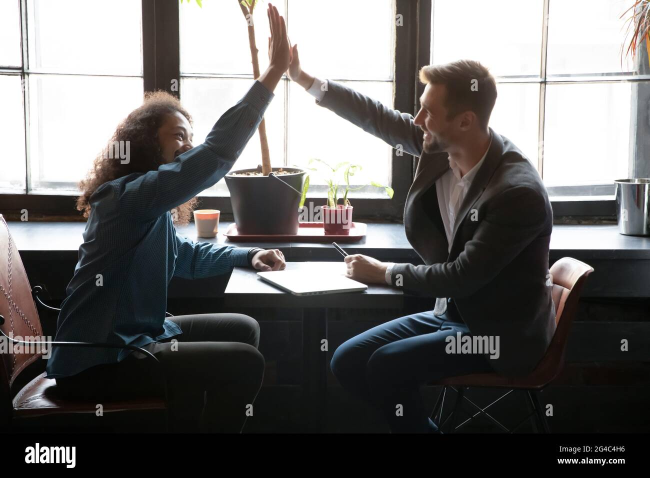 Happy young african american man giving high five to partner Stock ...