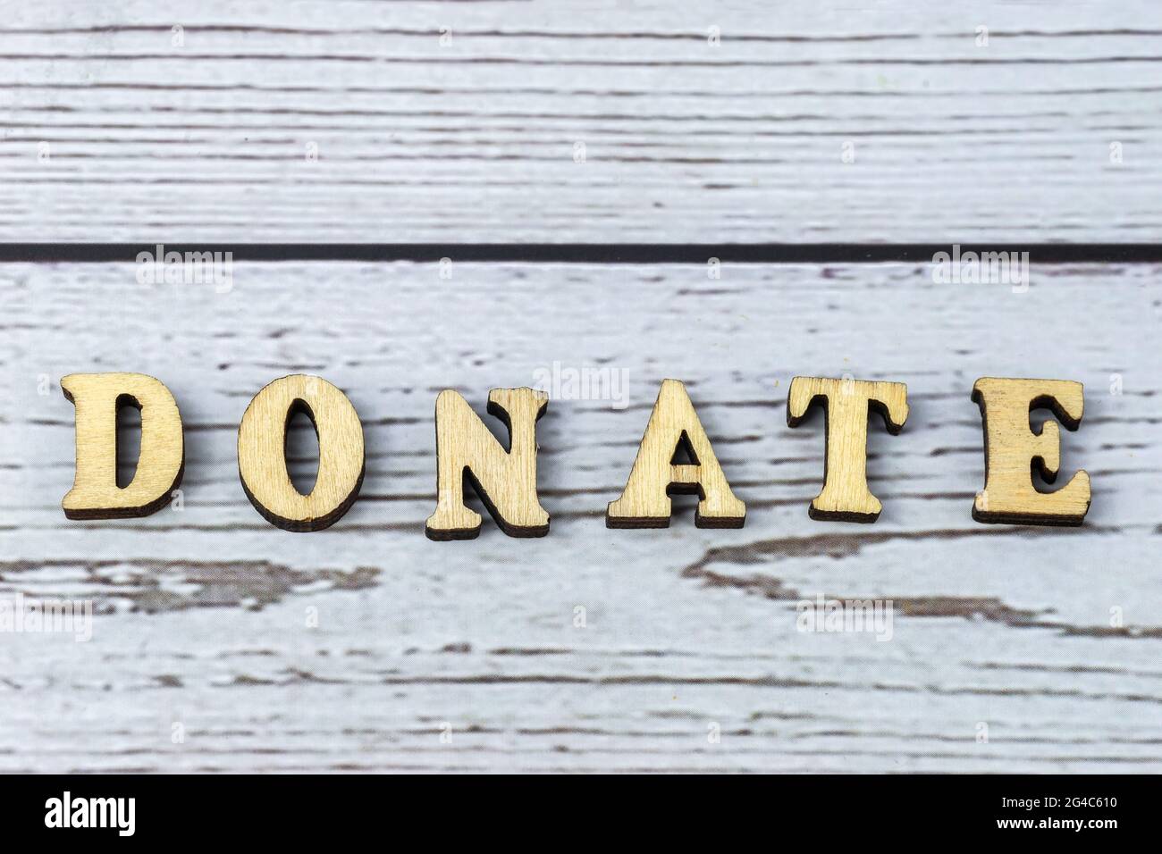 donate. Wooden letters on the office desk, informative and ...