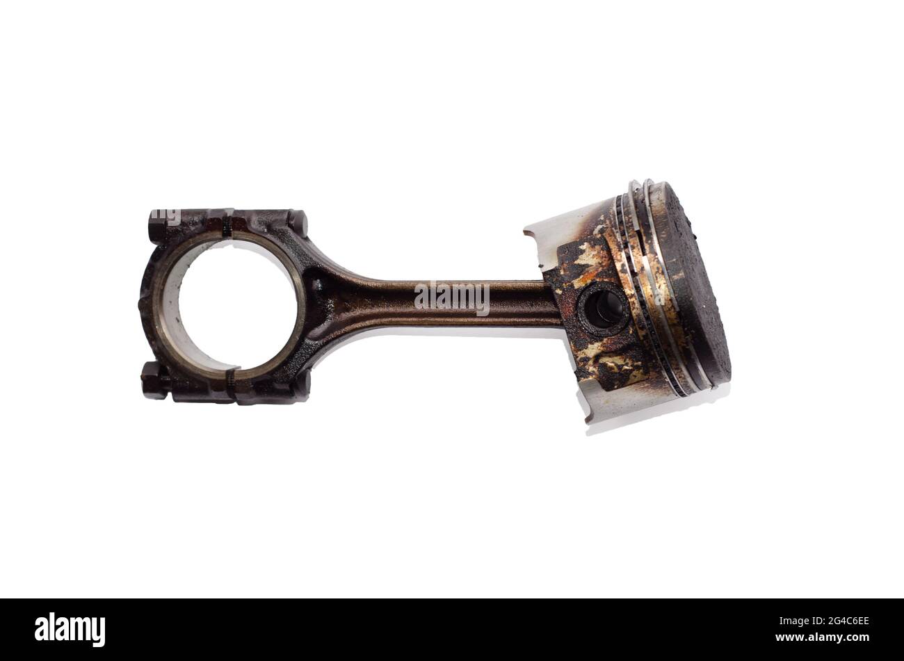 A closeup shot of piston with carbon deposits and connecting rod ...