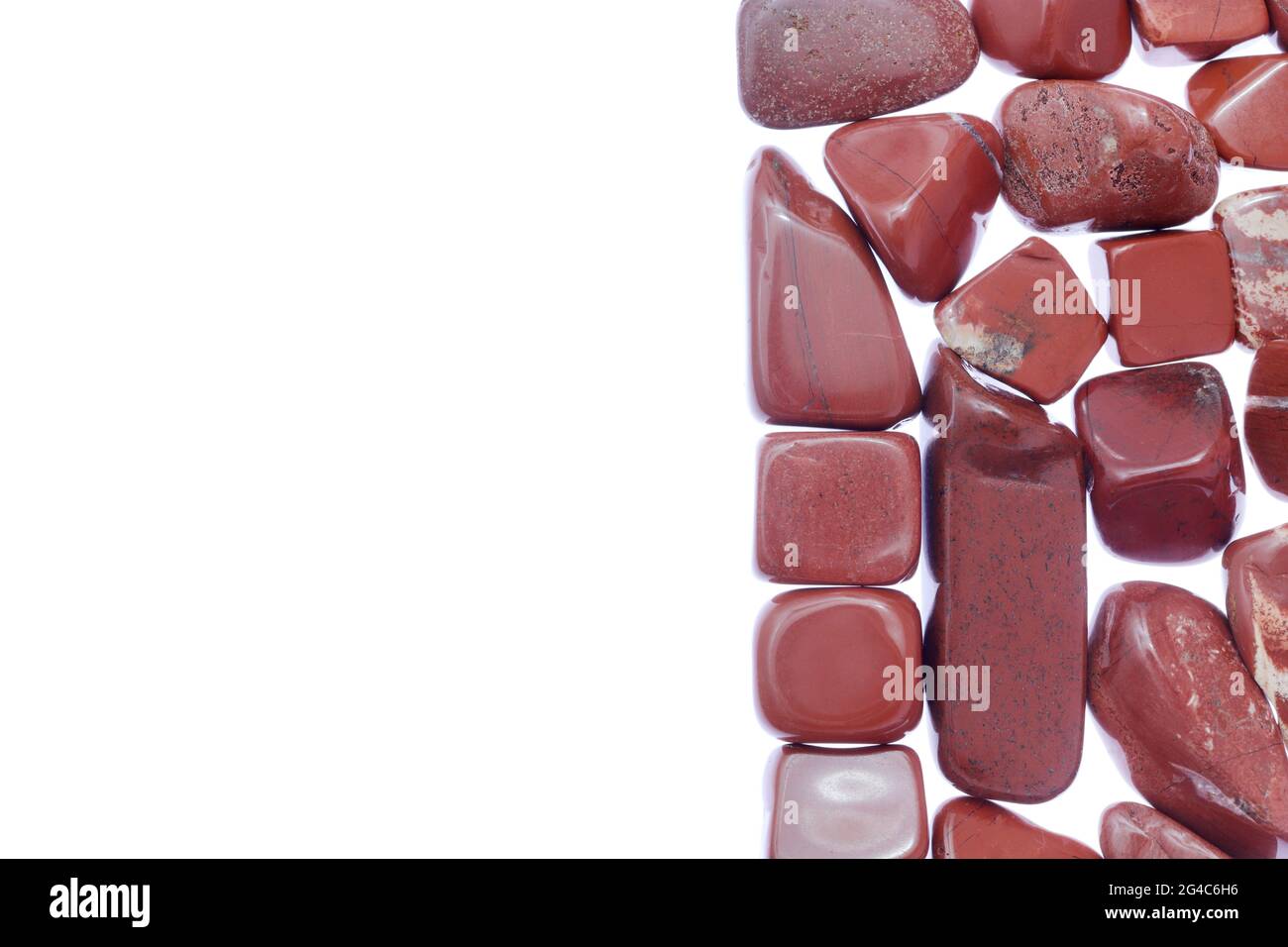 Red jasper heap jewel stones texture on half white light isolated ...