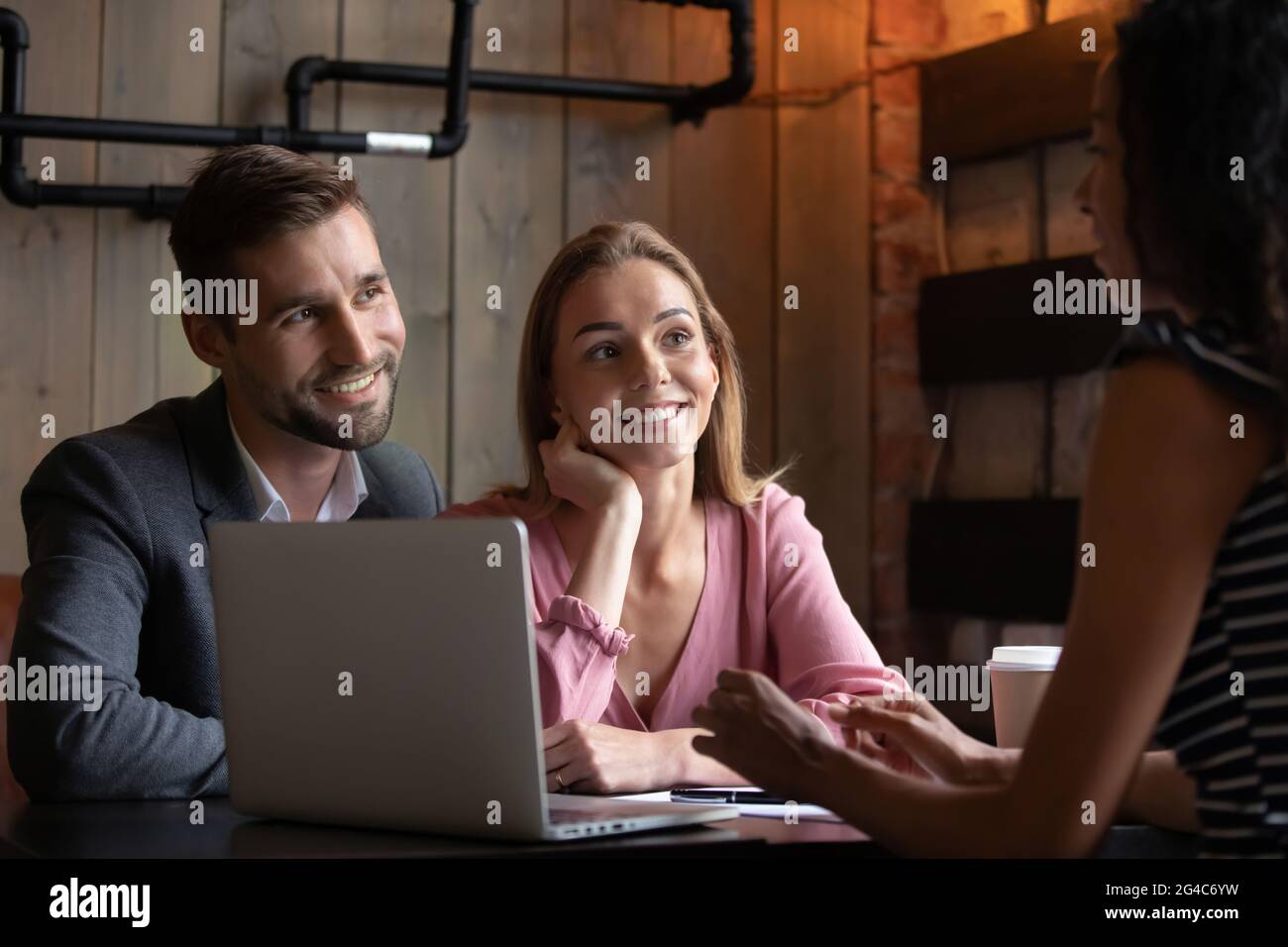 Happy excited young family couple meeting real estate agent Stock Photo ...