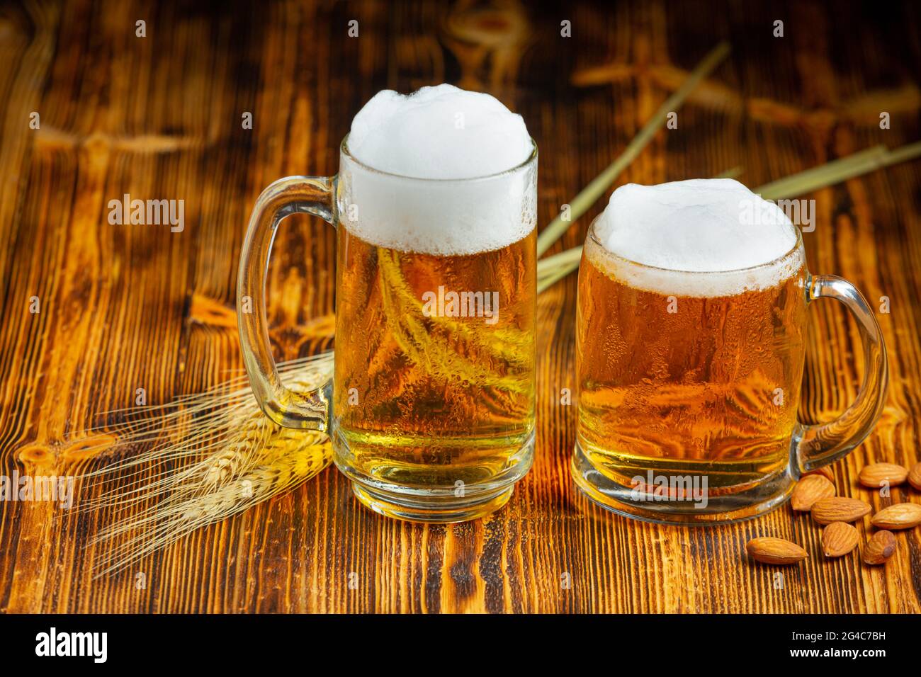 A glass of beer is placed on the wooden floor Stock Photo - Alamy