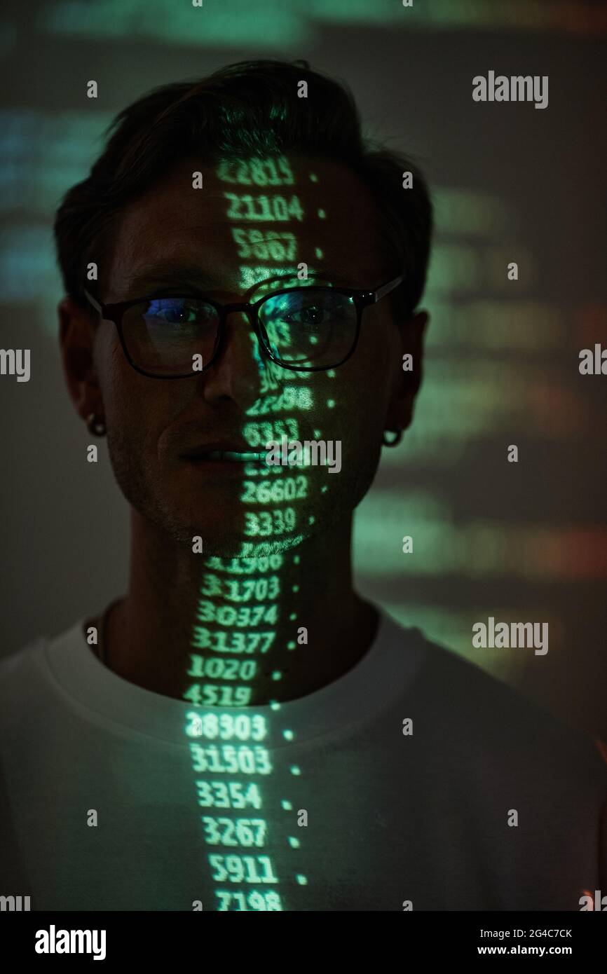 Hacker working on personal computer projecting code numbers and ...