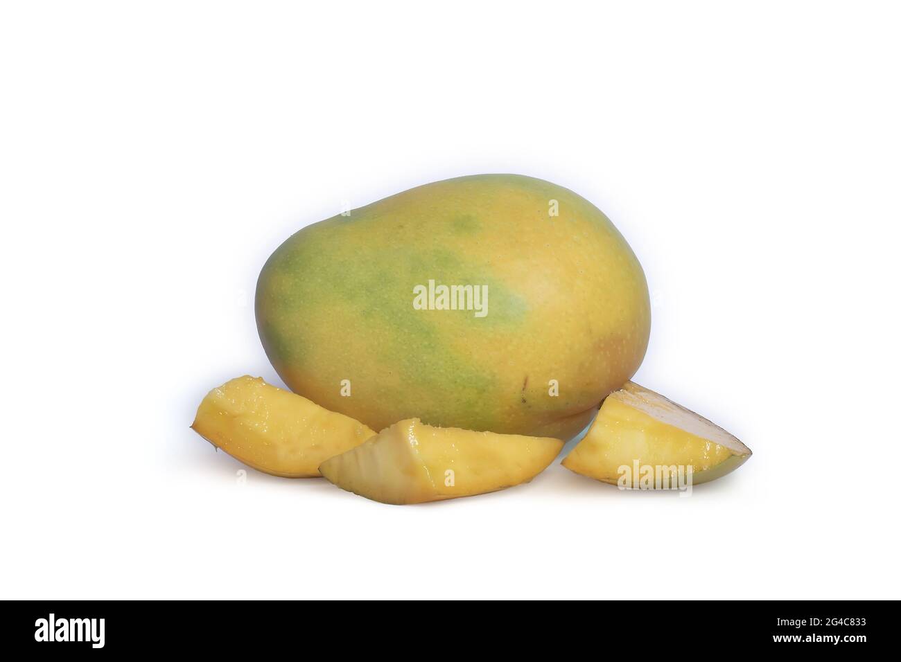 A green-yellowish mango with three sliced pieces Stock Photo - Alamy