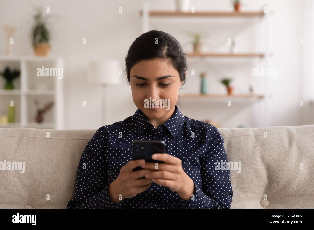 Indian woman use smartphone browsing internet at home Stock Photo - Alamy