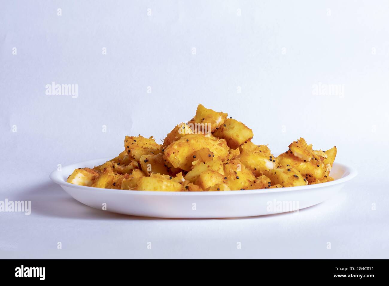 A plate of cooked food with a white background Stock Photo - Alamy
