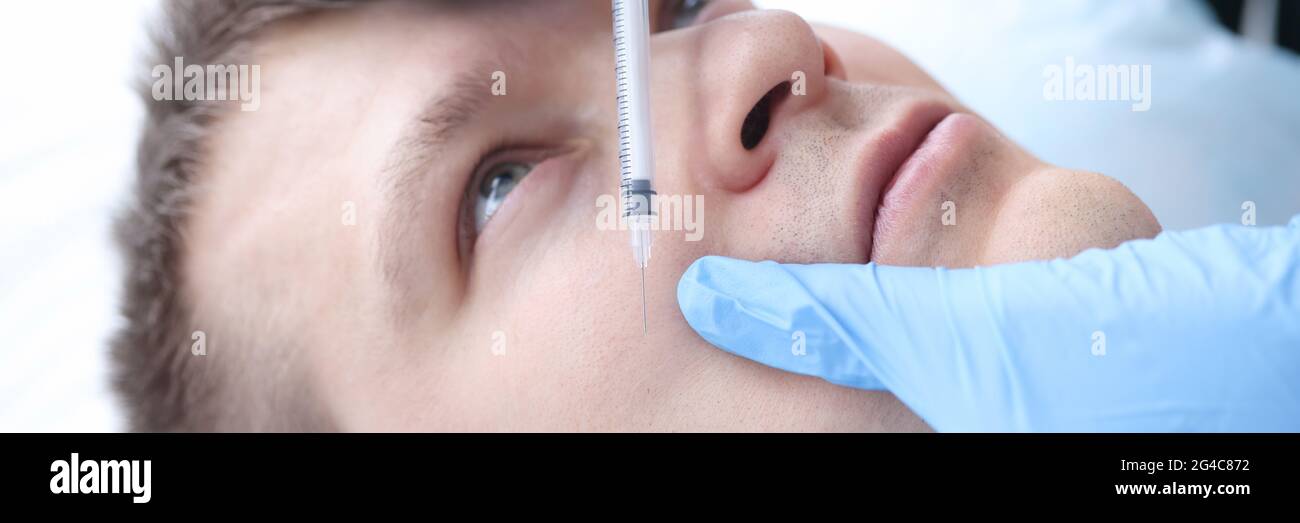Beautician making injection into face of male patient Stock Photo - Alamy