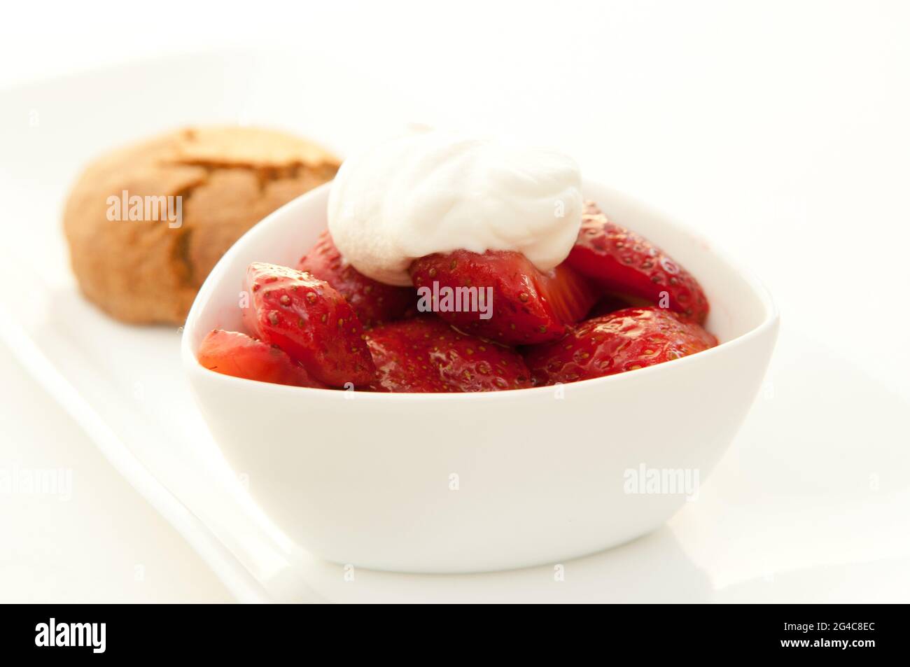 A closeup shot of a bowl with strawberries and cream on top Stock Photo ...