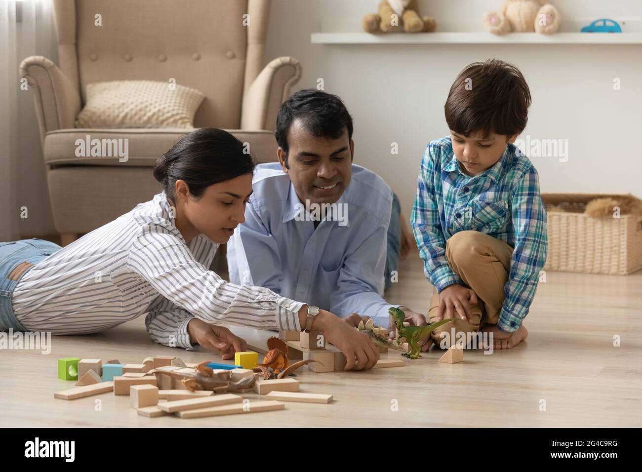 Happy Indian family with small son play toys at home Stock Photo - Alamy