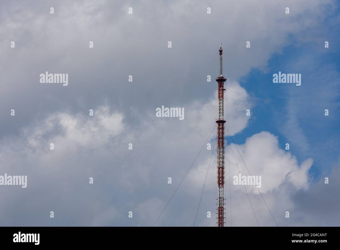 tall metal frame television tower on cloudy sky daylight background ...